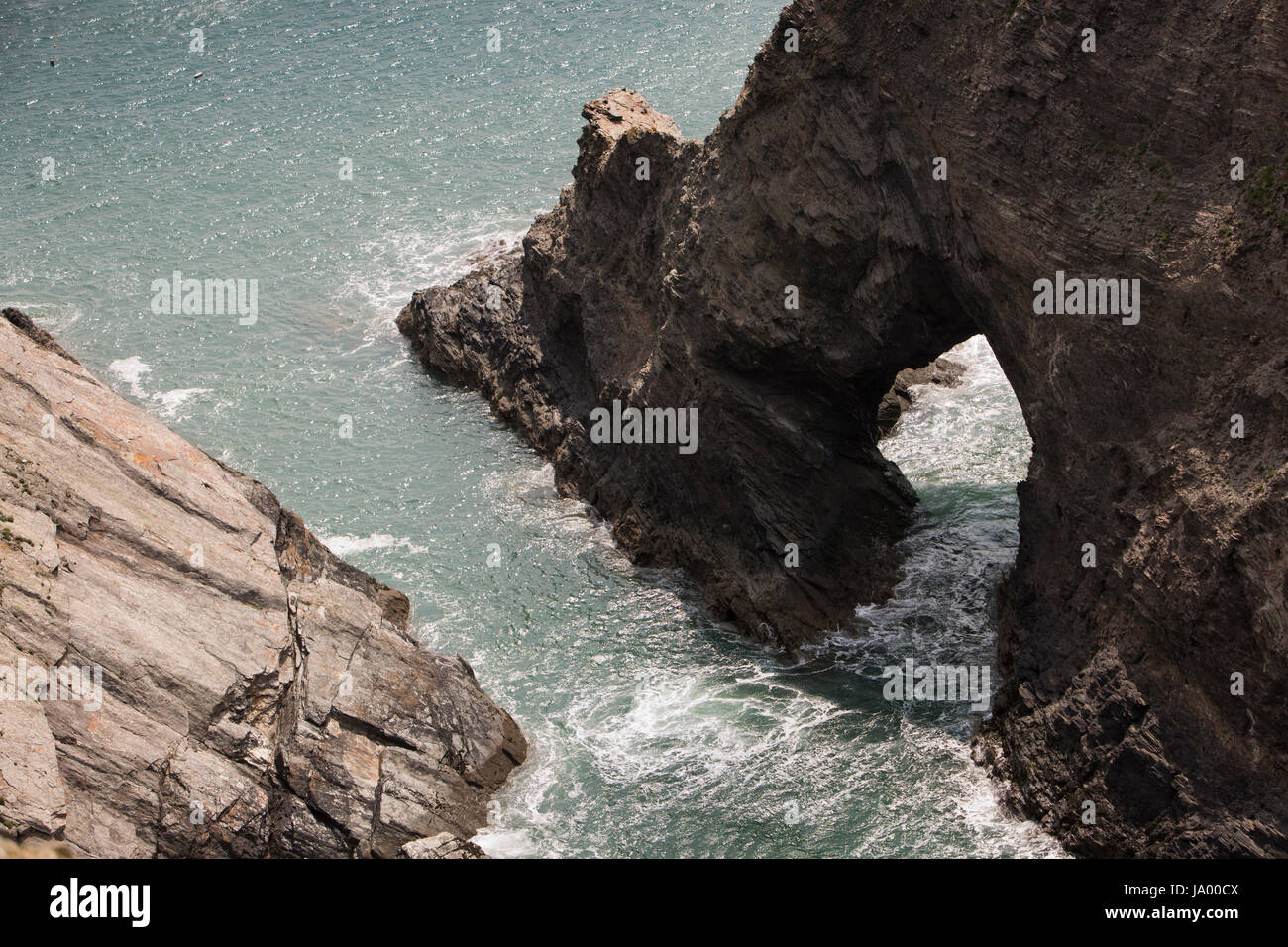 UK, Wales, Pembrokeshire, Solva, natural stone arch in cliffs below ...