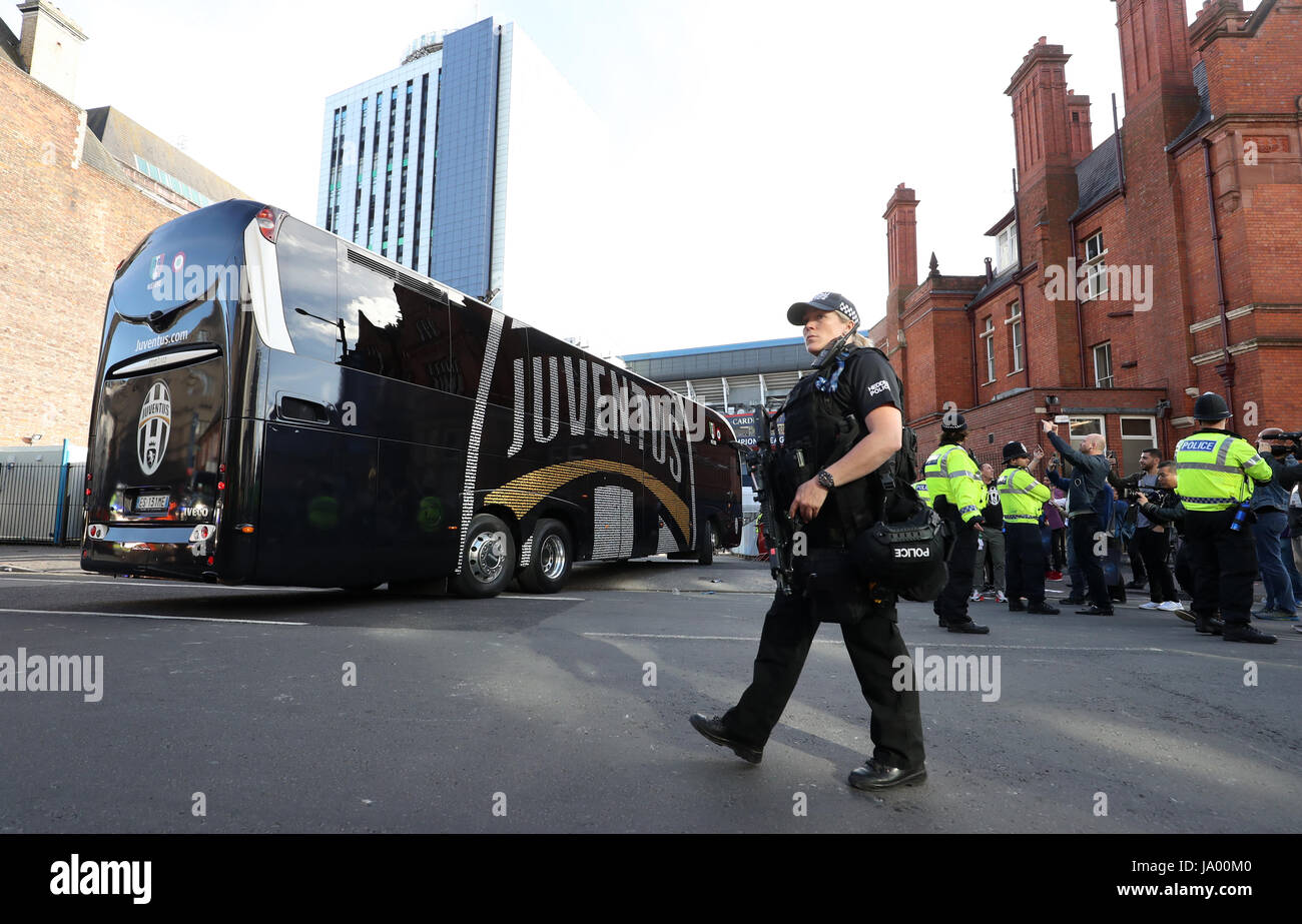 A security guard walks by as the Juventus coach drives in during the ...