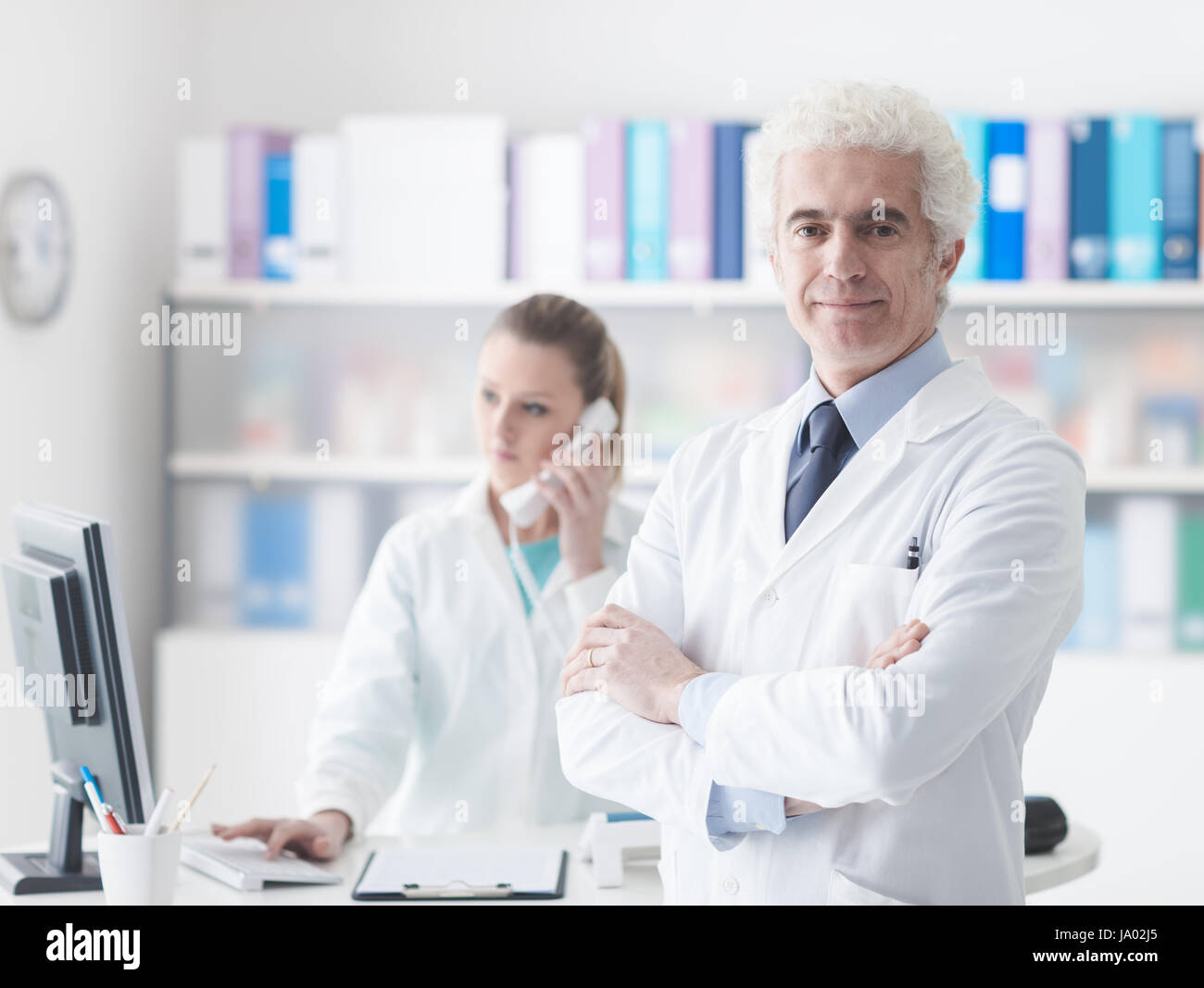 Doctor answering phone desk hi-res stock photography and images - Alamy