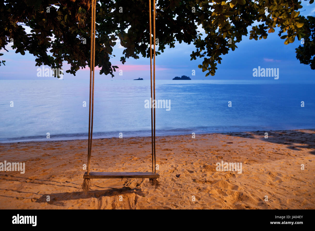 Swing on beautiful sunset at the beach Stock Photo - Alamy