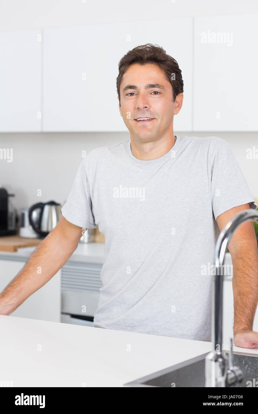 Handsome man standing in kitchen Stock Photo - Alamy