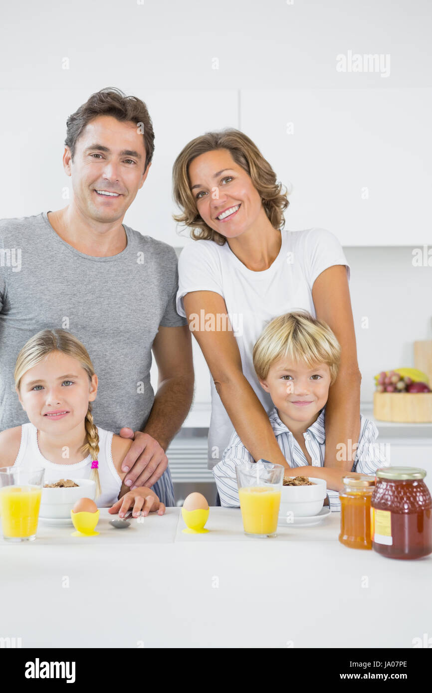 Smiling family at breakfast in the kitchen Stock Photo - Alamy