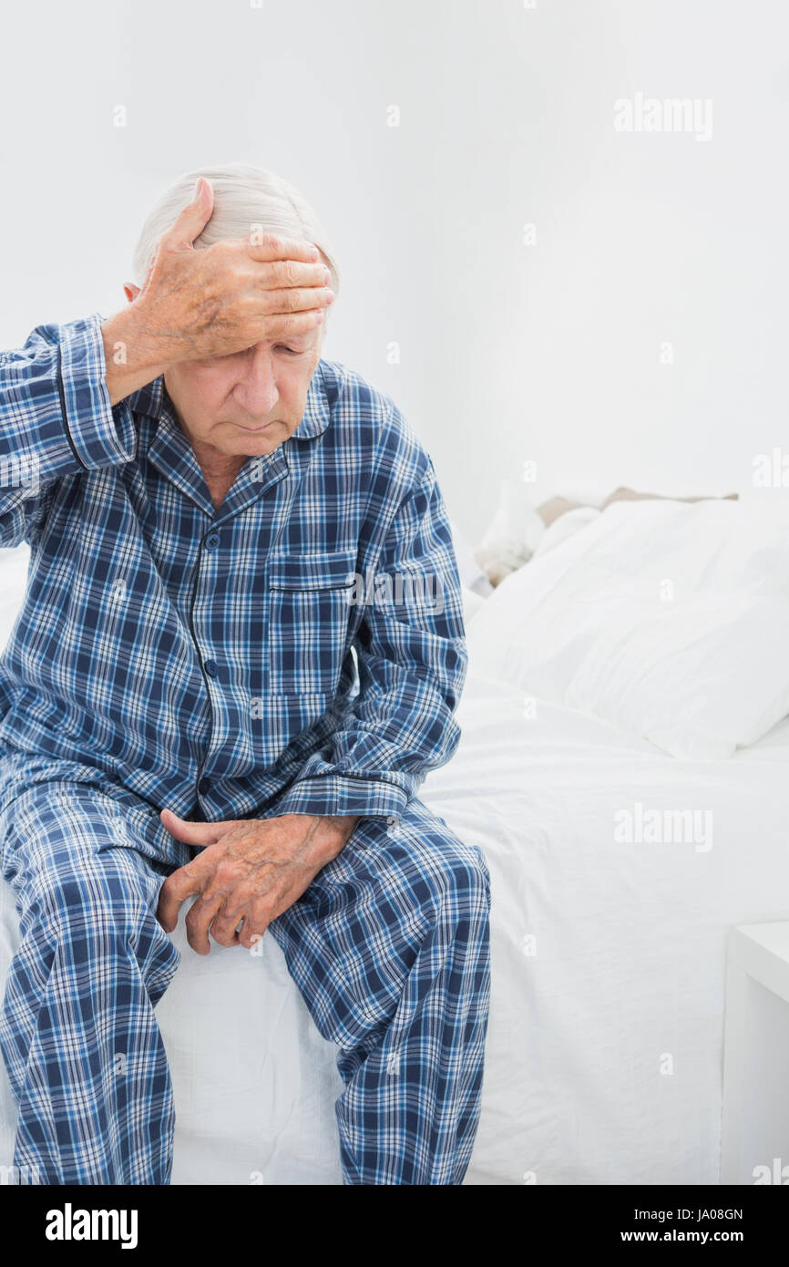 Old man suffering on the bed in the bedroom Stock Photo - Alamy