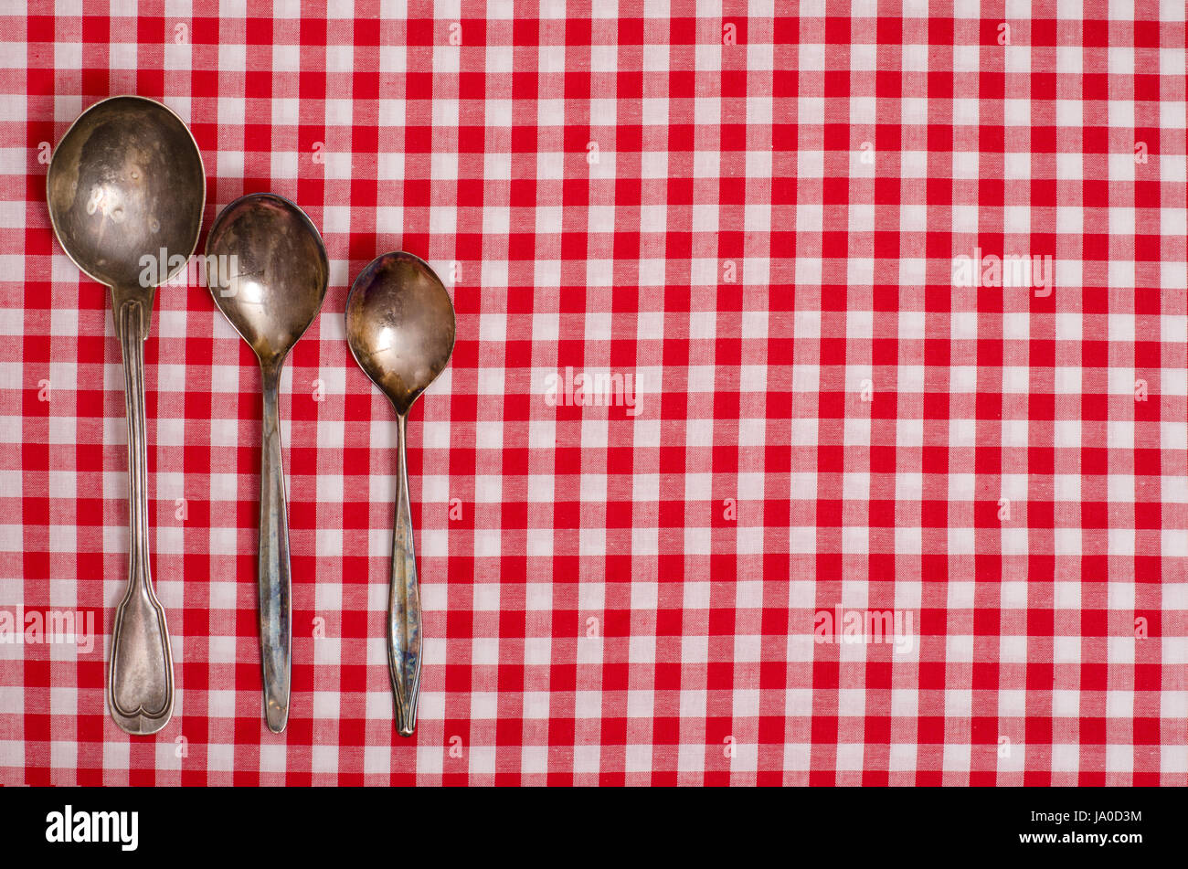 spoons from silver on checkered cloth Stock Photo - Alamy