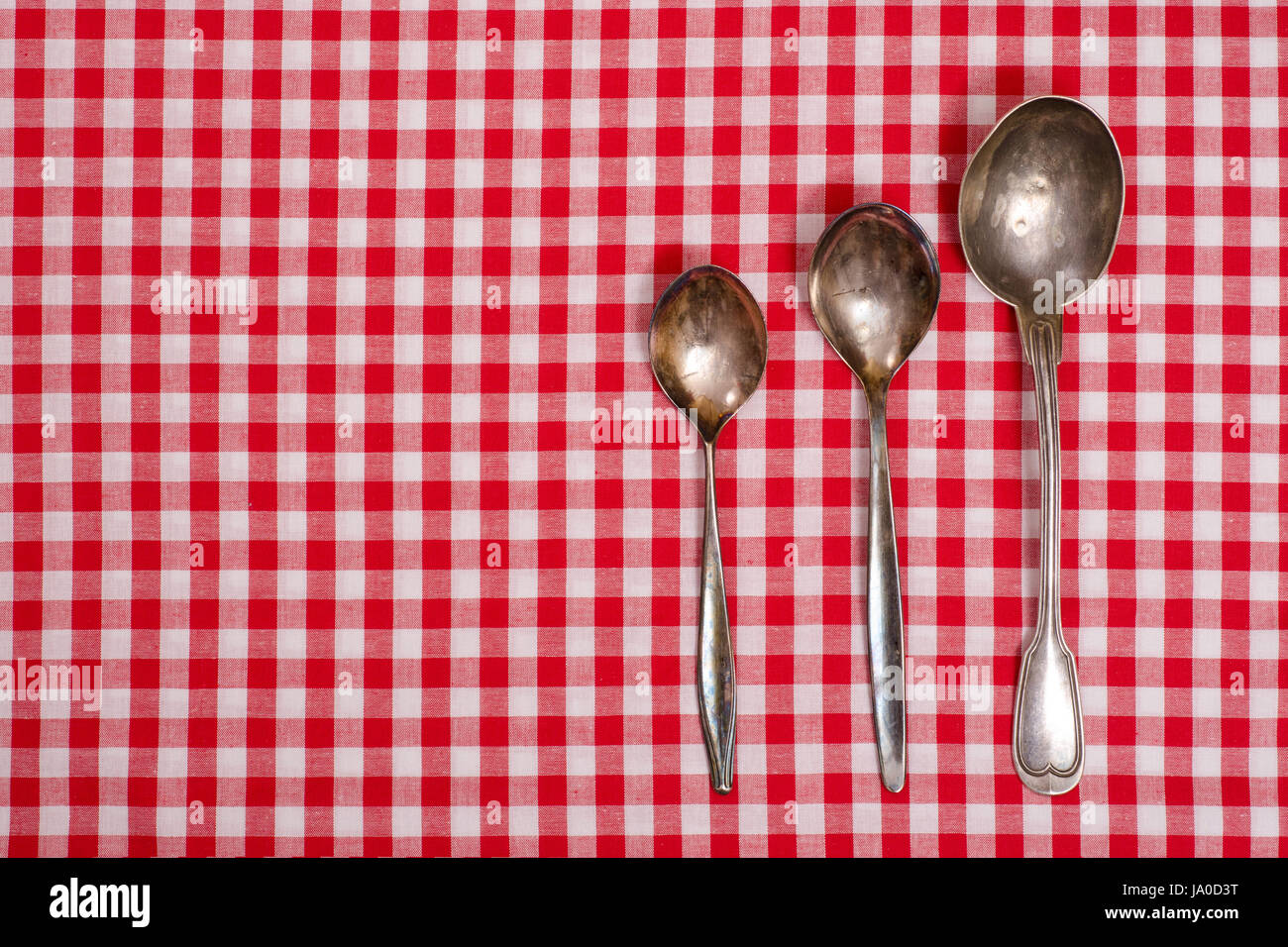 red and white checkered cloth and three old spoon Stock Photo - Alamy
