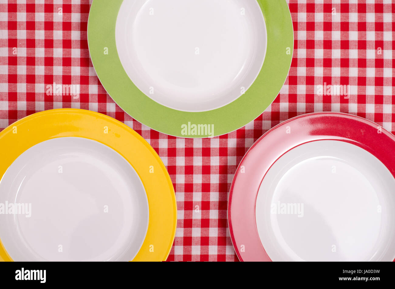 red,green and yellow plates on a table Stock Photo - Alamy