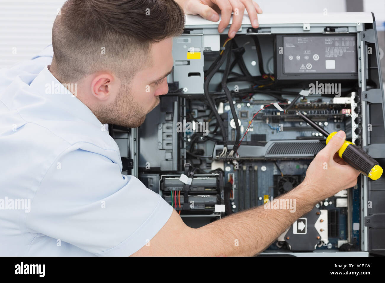 Young computer engineer working on cpu at workplace Stock Photo - Alamy