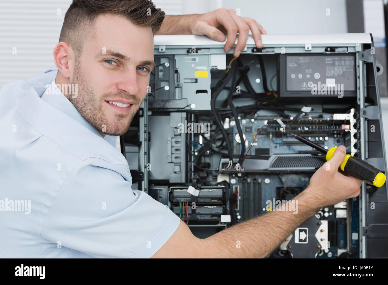 Portrait of young computer engineer working on cpu at workplace Stock ...