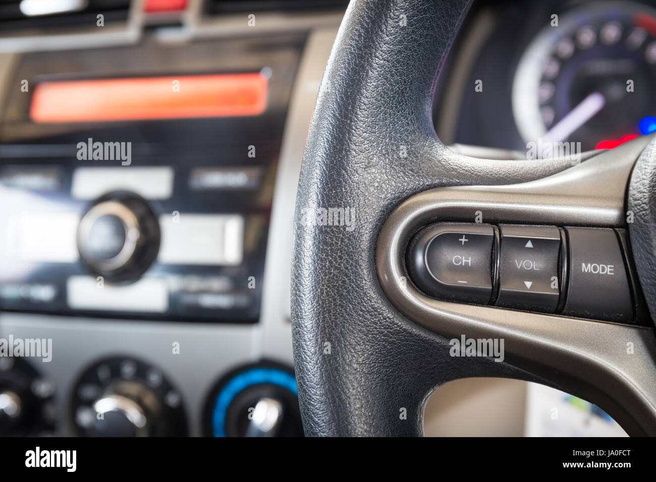Modern car audio control multifunction buttons on a steering wheel ...