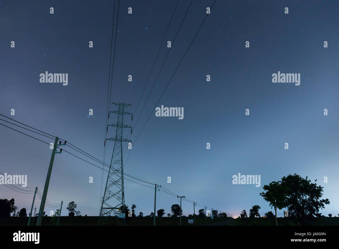 High voltage pole in night time with star on sky background Stock Photo ...