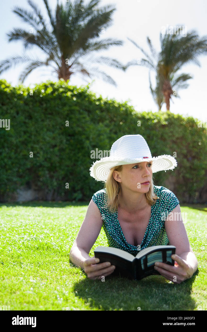 woman with book under the palm trees Stock Photo - Alamy