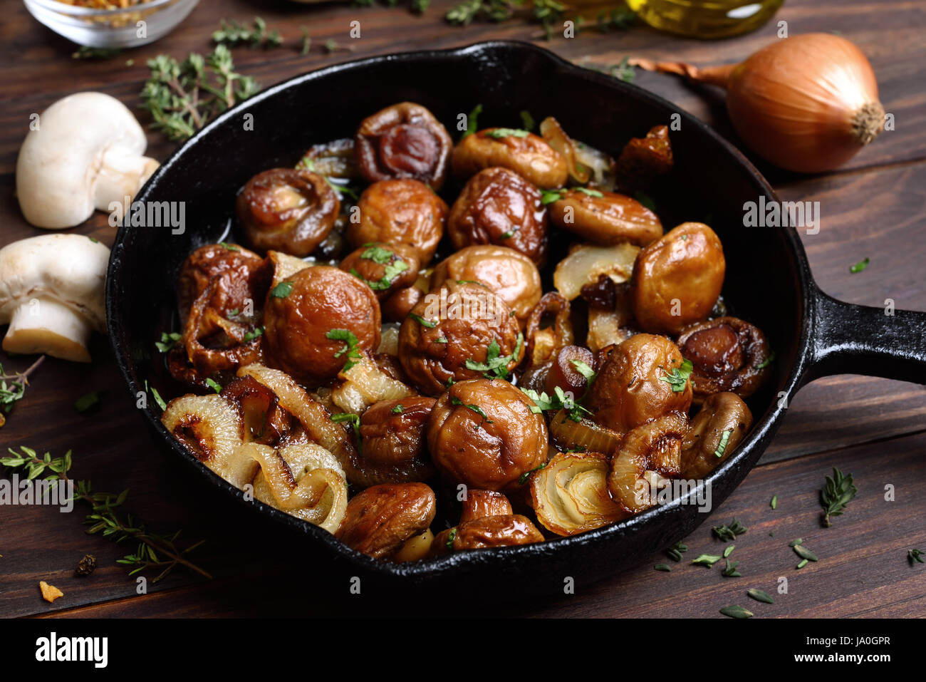 Cooked mushrooms in frying pan on wooden table, close up view Stock ...