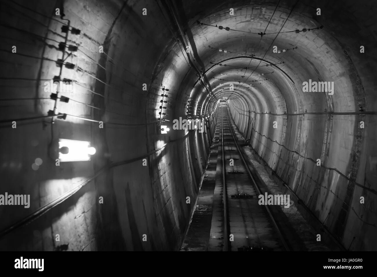 Underground facility with a big tunnel leading deep down. Abstract ...