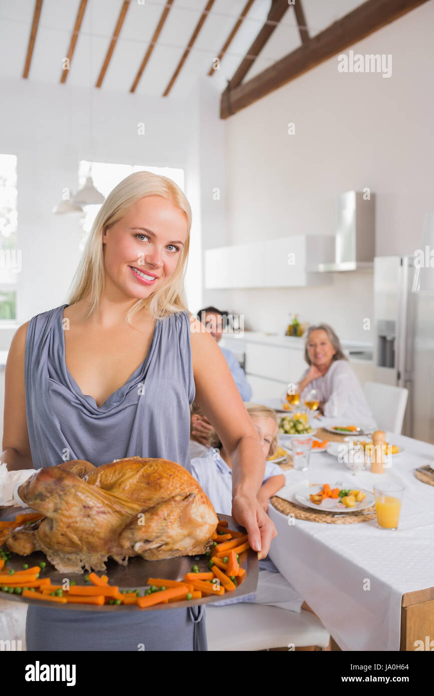 Smiling blonde woman showing the roast turkey for thanksgiving Stock ...