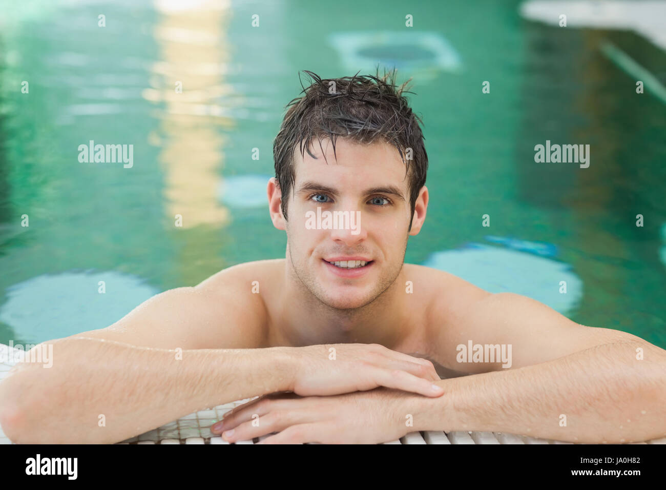 Smiling handsome man in a swimming pool Stock Photo - Alamy