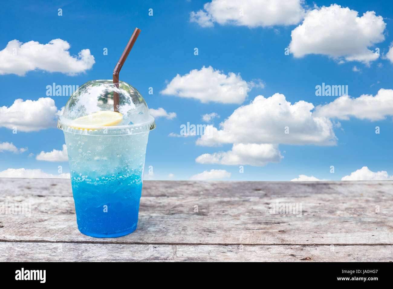 blue lemon soda on wooden table with blue sky background Stock Photo ...