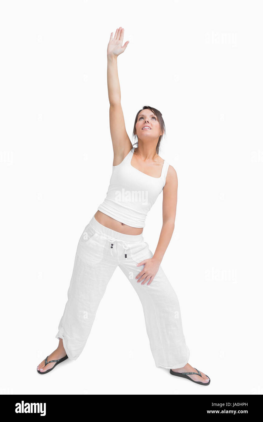 Young woman performing stretching exercise over white background Stock ...