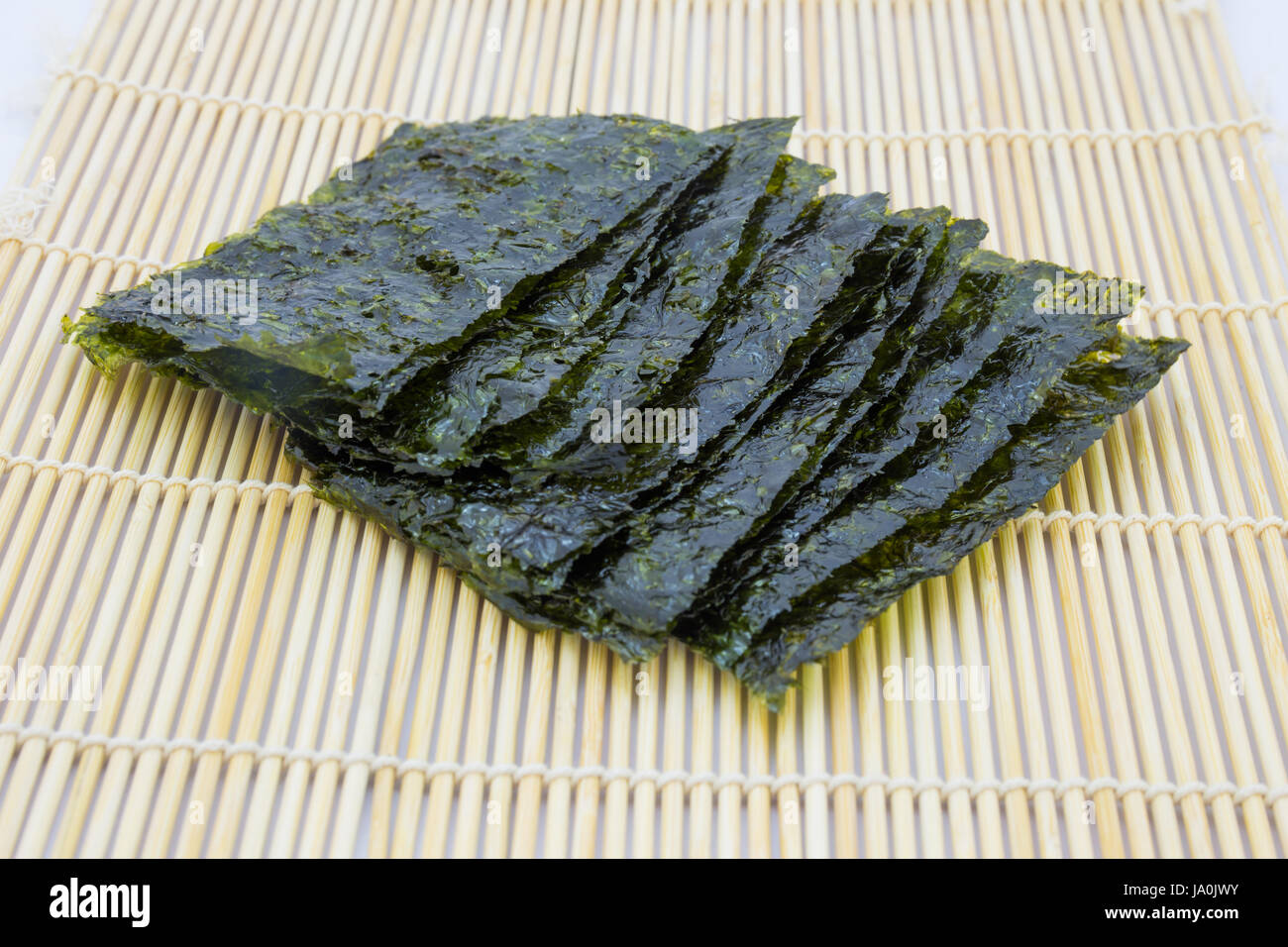closeup roasted seaweed snack (kim nori) on traditional bamboo mat ...