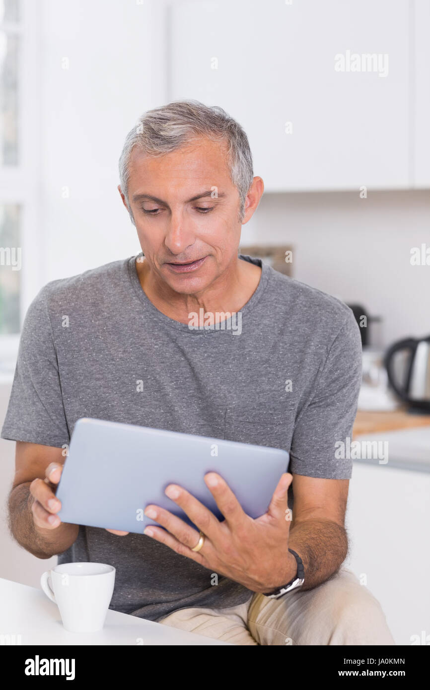 Focused man using his digital tablet Stock Photo - Alamy