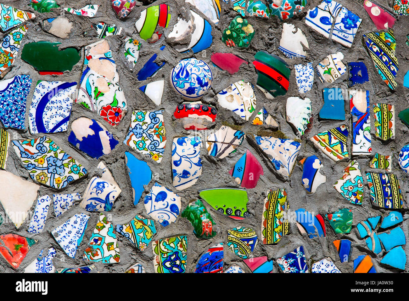 Wall with broken ceramic plates colored fragments Stock Photo - Alamy