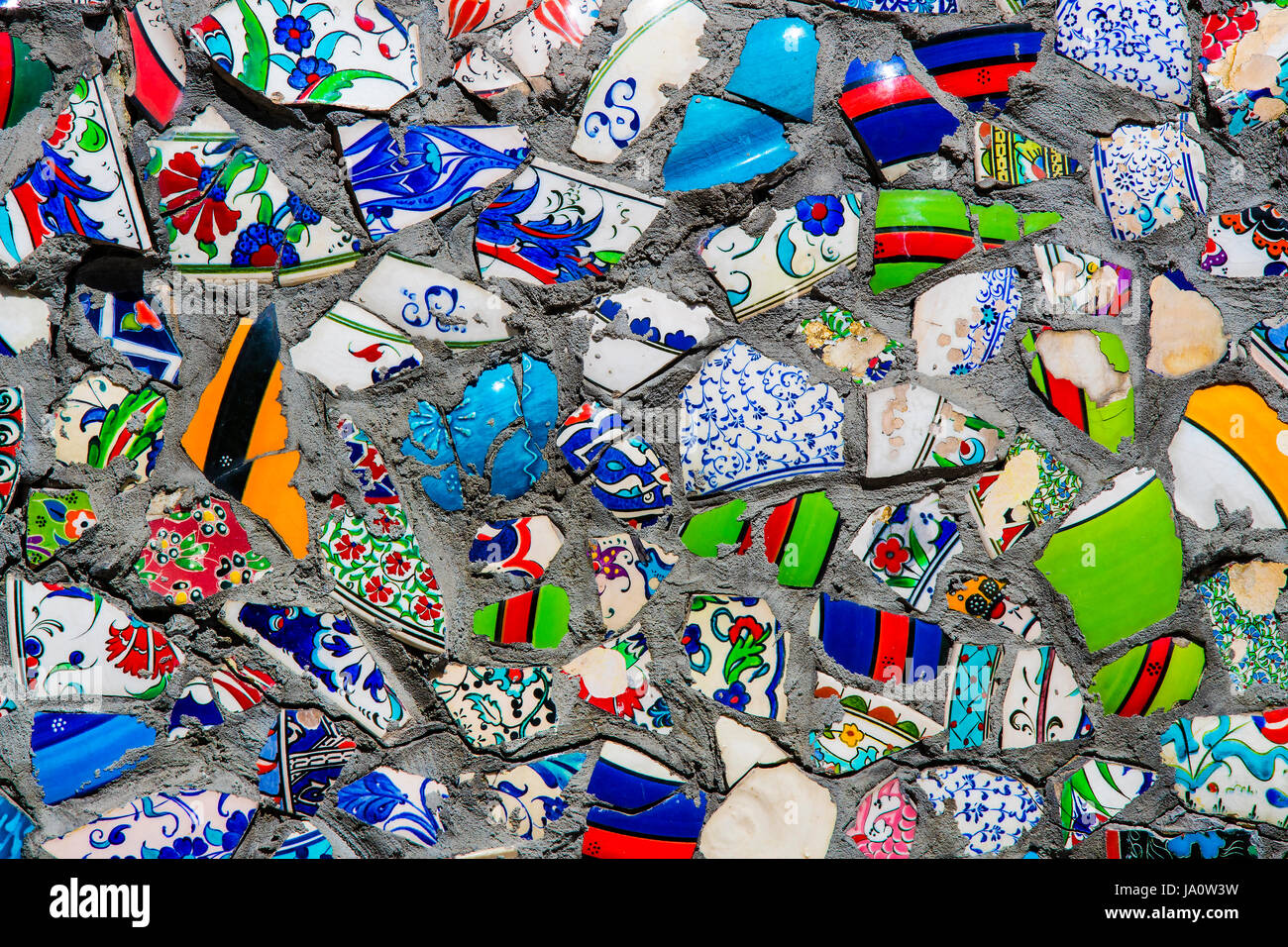 Wall with broken ceramic plates colored fragments Stock Photo - Alamy