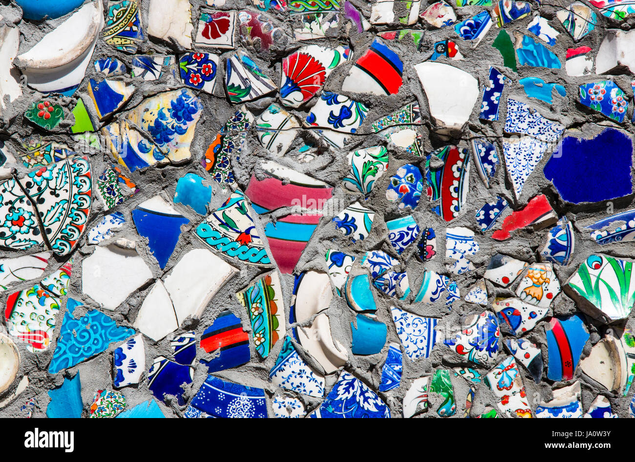 Wall with broken ceramic plates colored fragments Stock Photo - Alamy