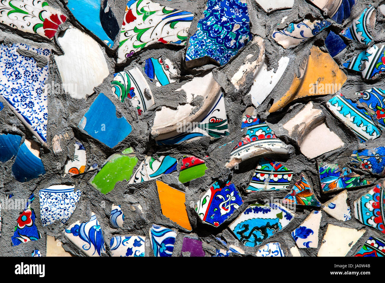 Wall with broken ceramic plates colored fragments Stock Photo - Alamy