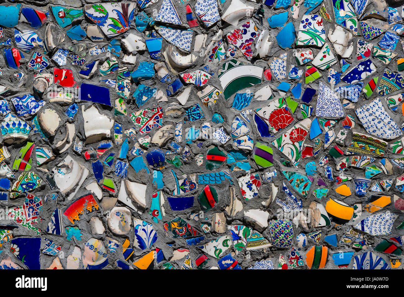 Wall with broken ceramic plates colored fragments Stock Photo - Alamy