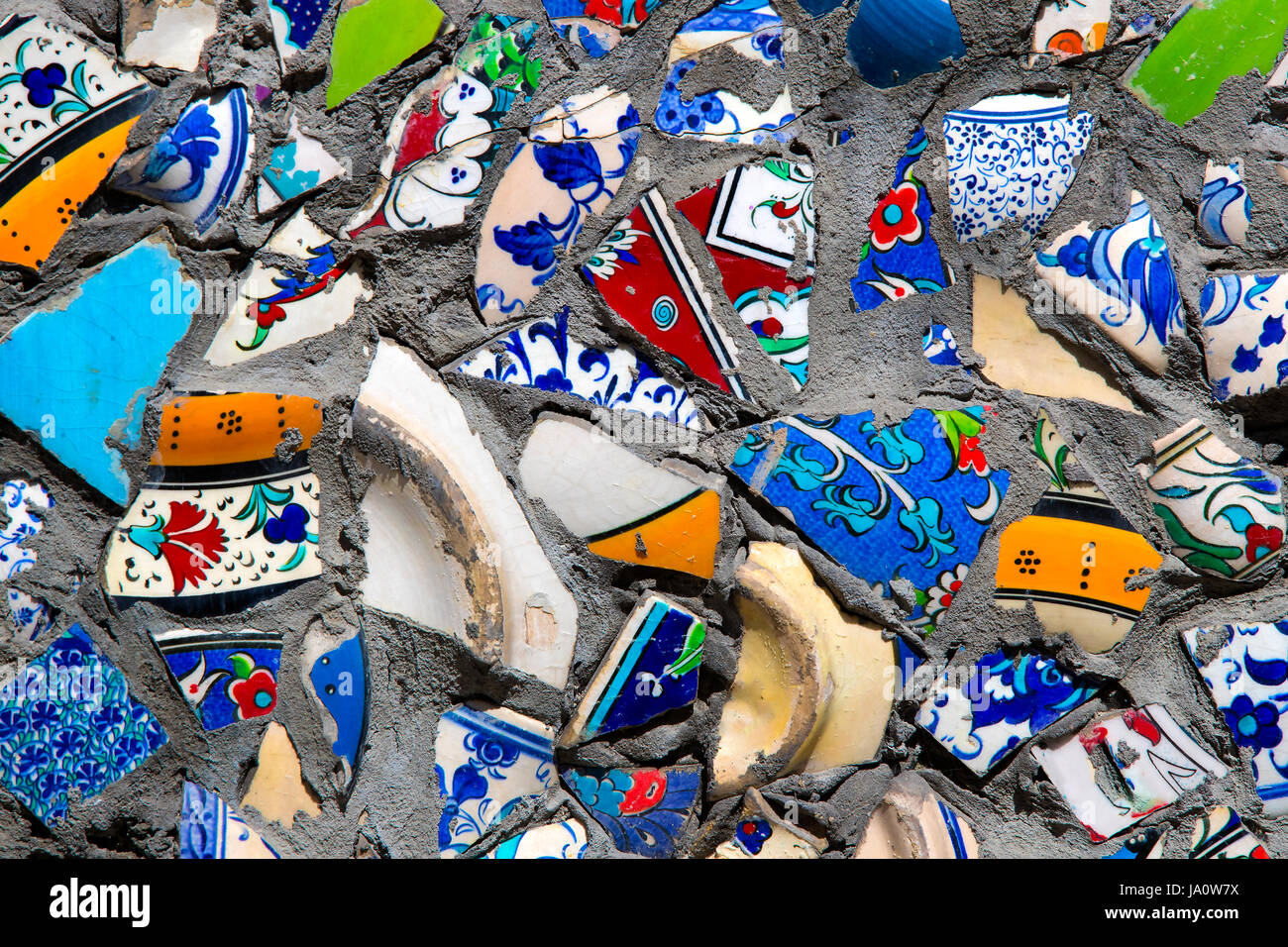 Wall with broken ceramic plates colored fragments Stock Photo - Alamy