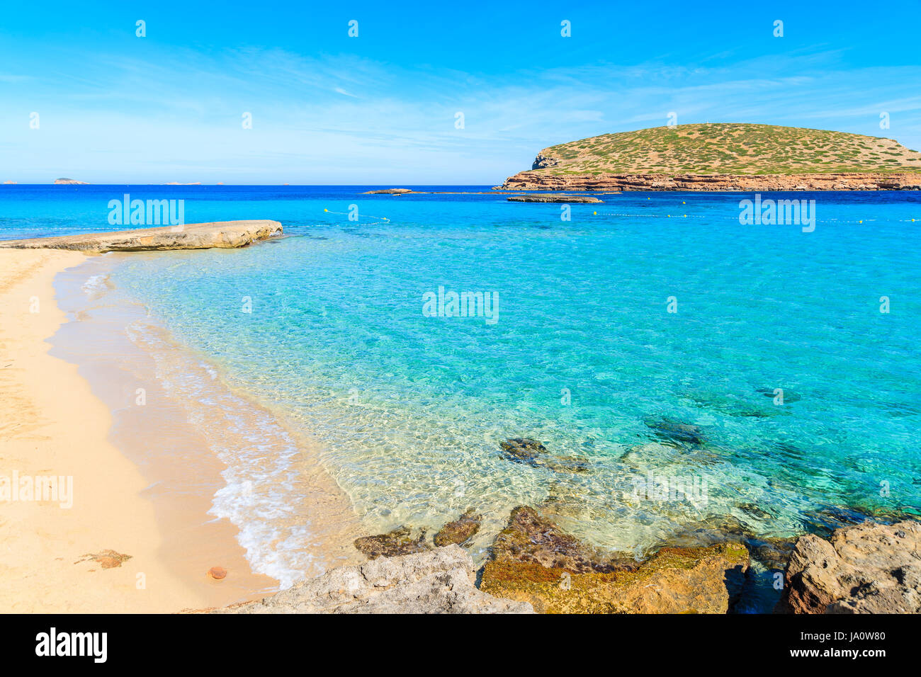 Sea waves on beautiful Cala Comte beach famous for its azure crystal ...