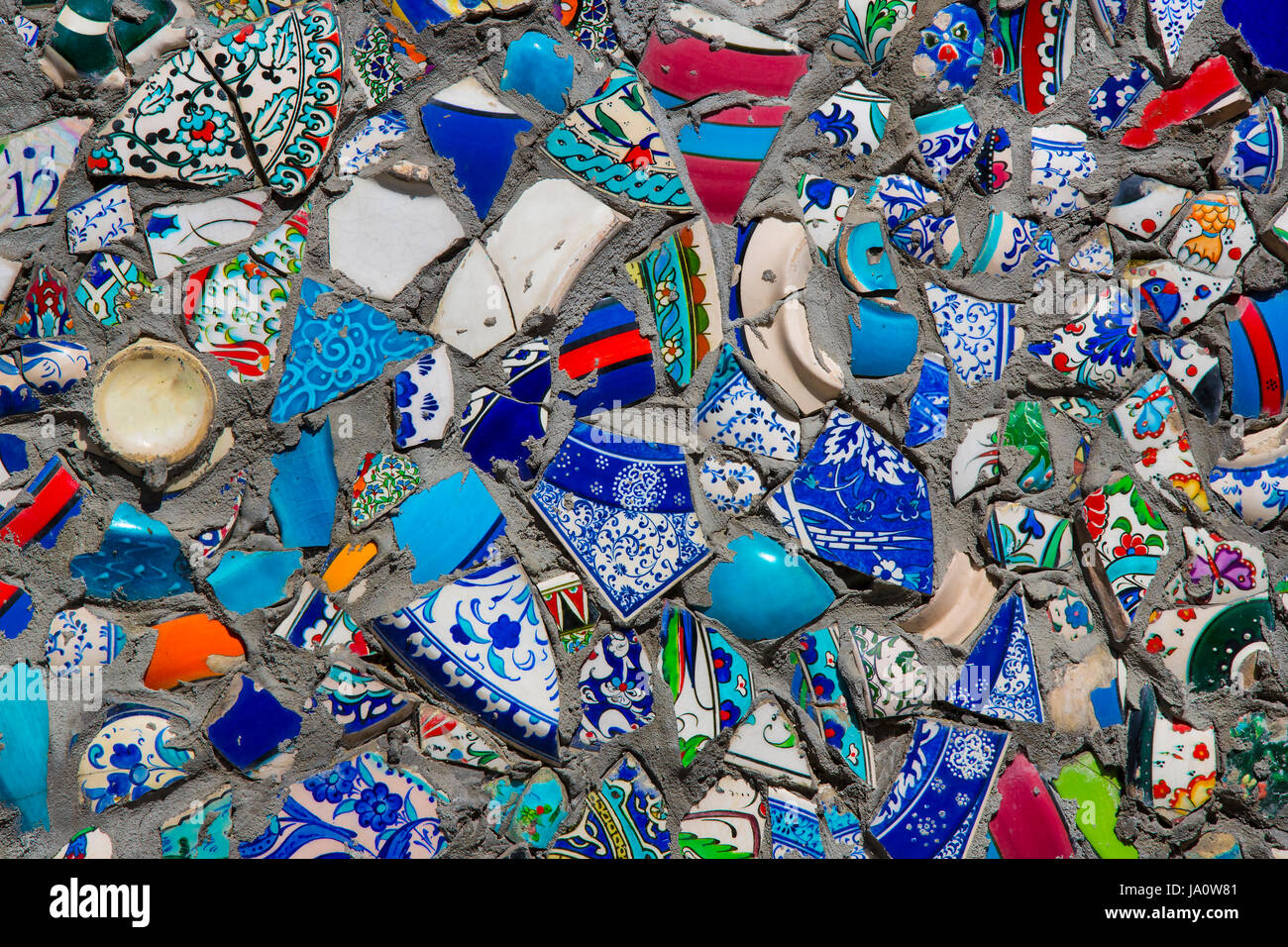 Wall with broken ceramic plates colored fragments Stock Photo - Alamy