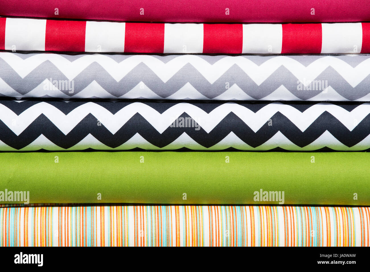 Background of the scrolls rolls colored colorful fabric Stock Photo - Alamy