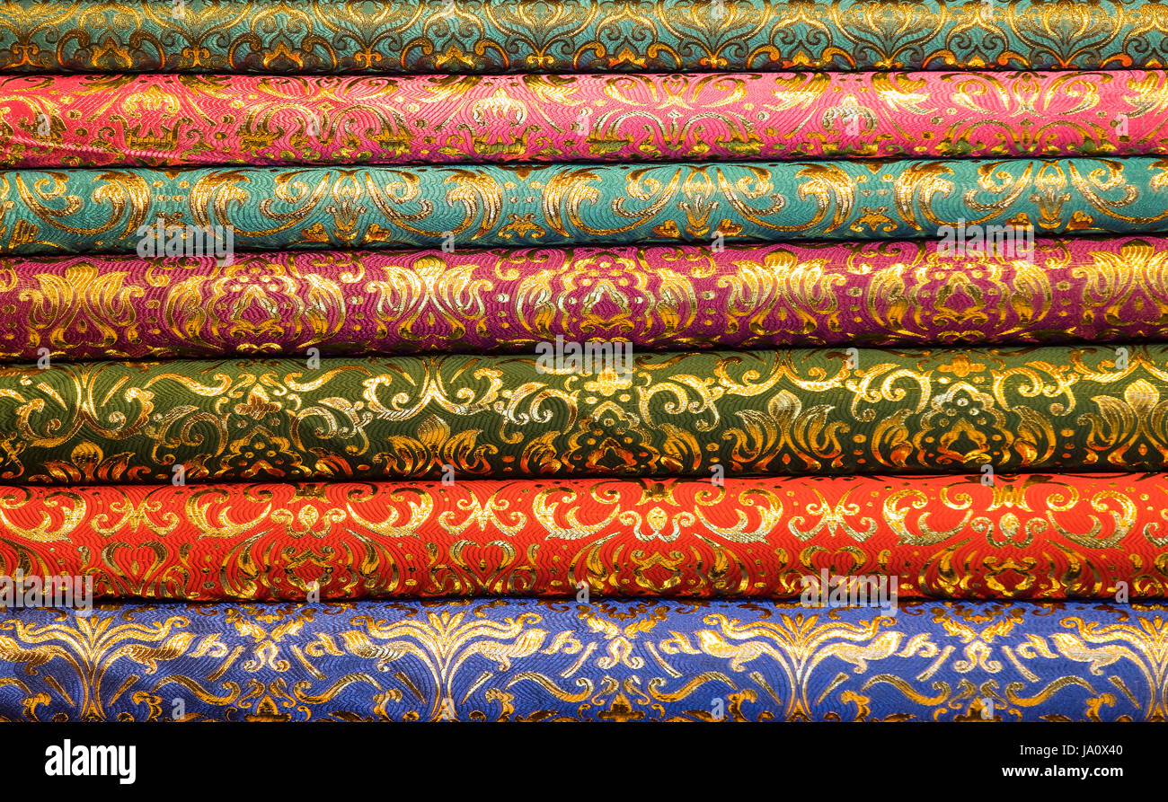 Background of the scrolls rolls colored colorful fabric Stock Photo - Alamy