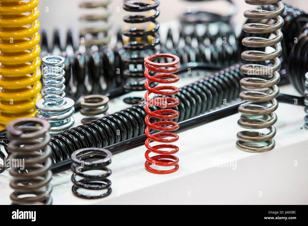 Multicolored metal of different sizes car springs Stock Photo - Alamy