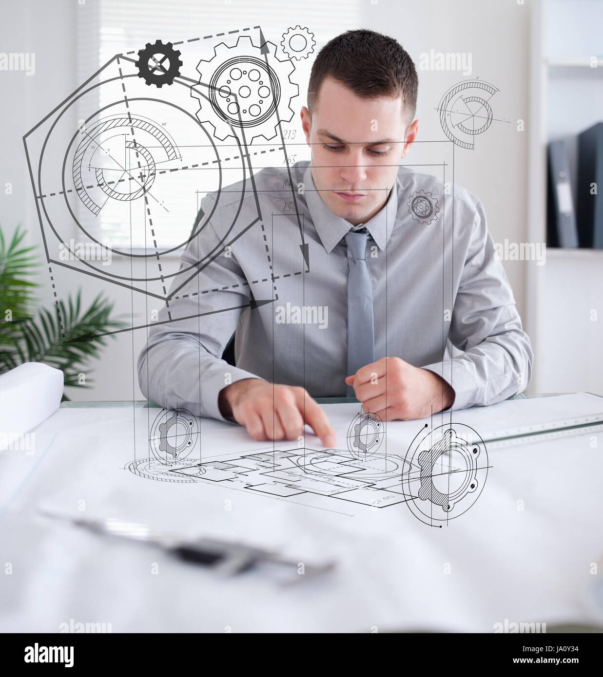 Architect at work in office with plan graphic Stock Photo - Alamy