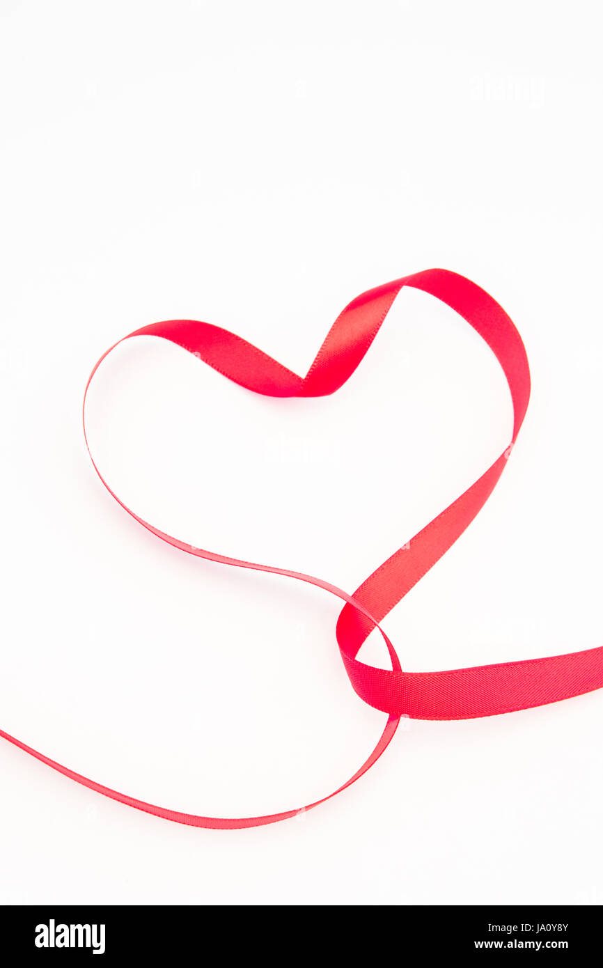 Pretty pink heart made out of ribbon on white background Stock Photo ...