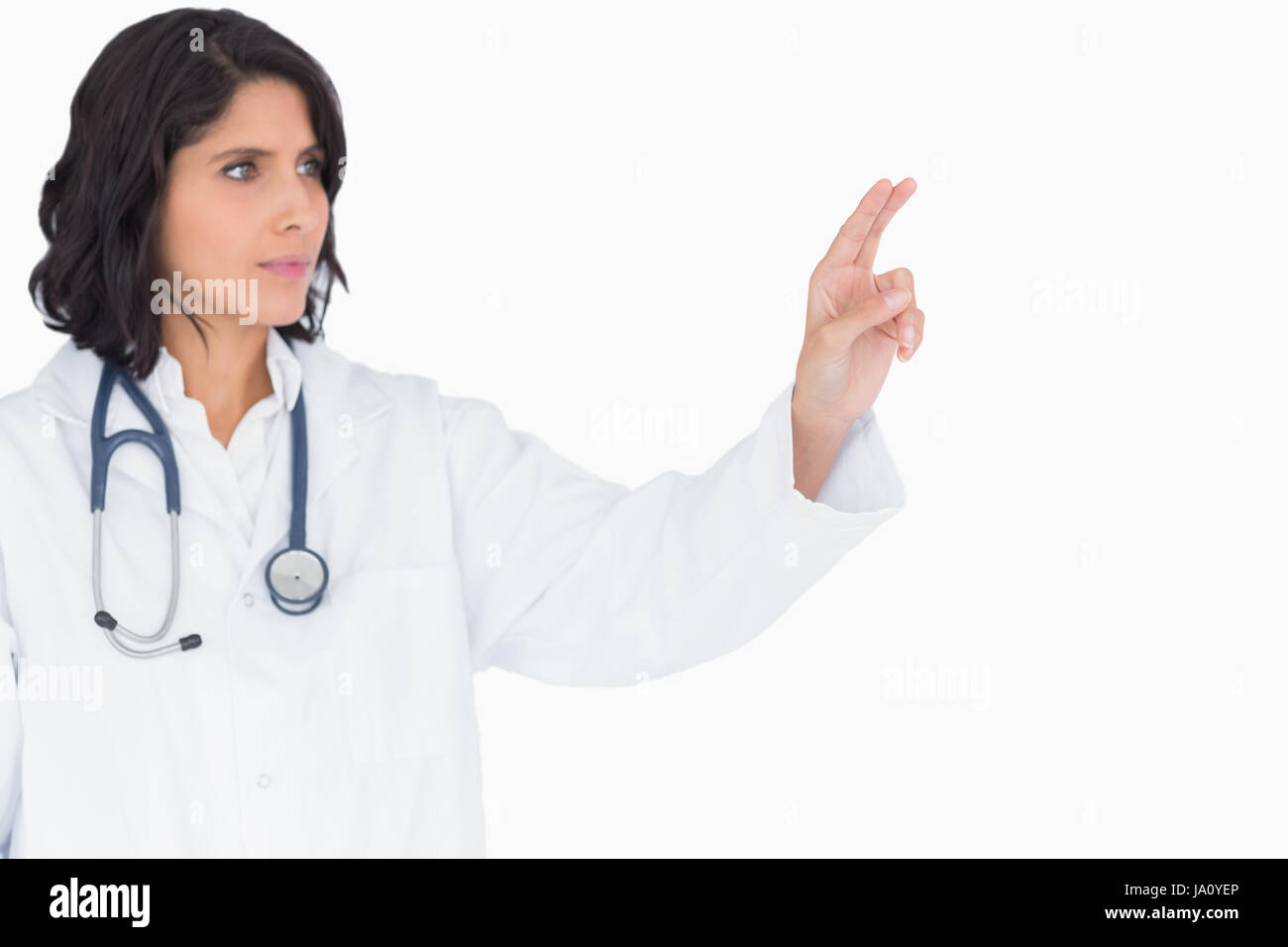 Doctor pointing to something on white background Stock Photo - Alamy