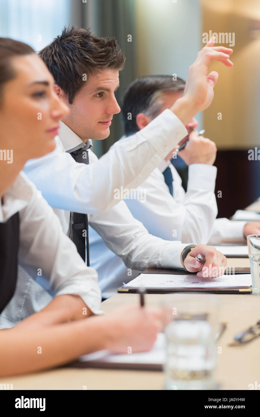 Businessman asking question during meeting Stock Photo - Alamy