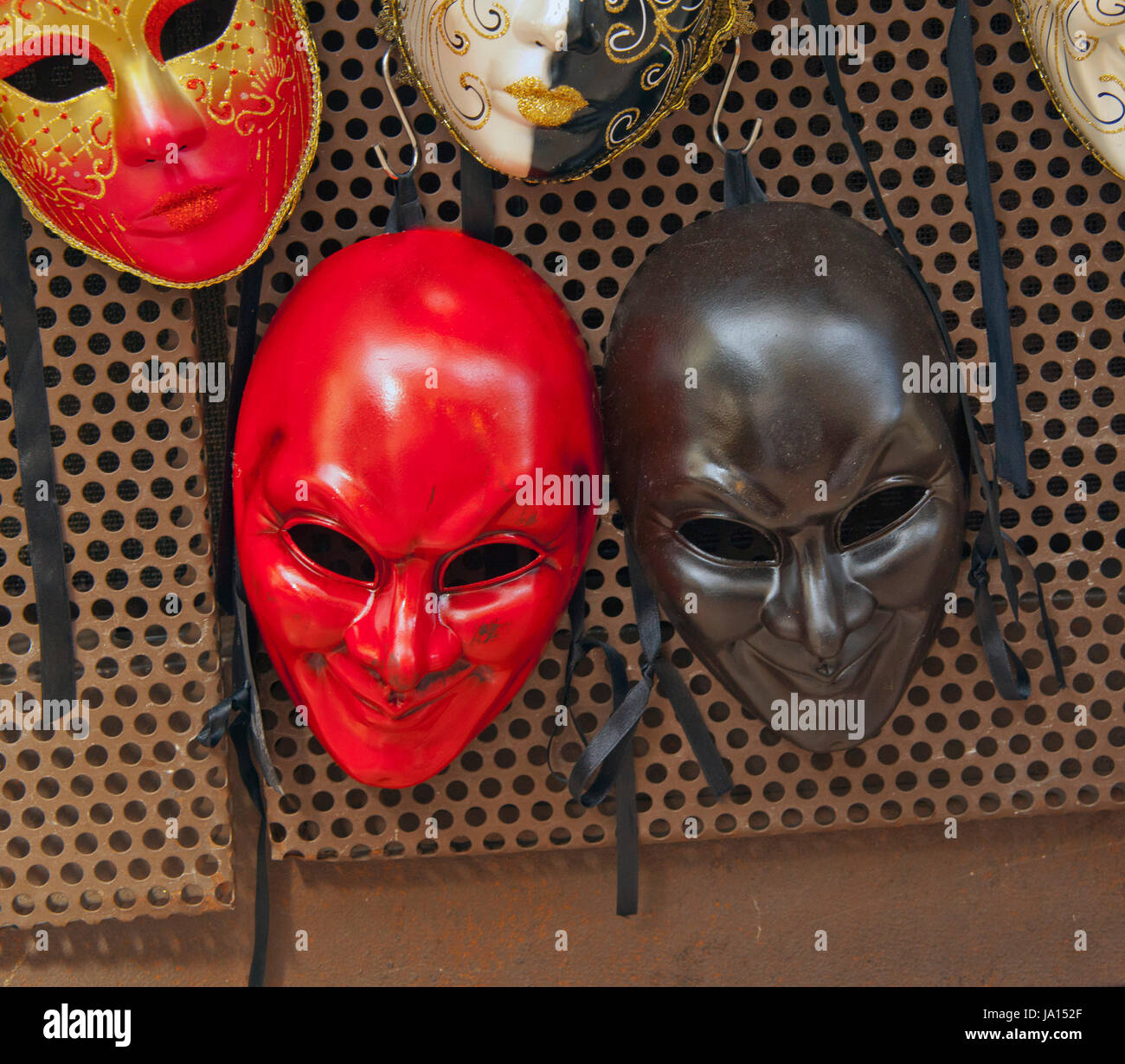 A couple of identical masks of opposite colours Stock Photo - Alamy
