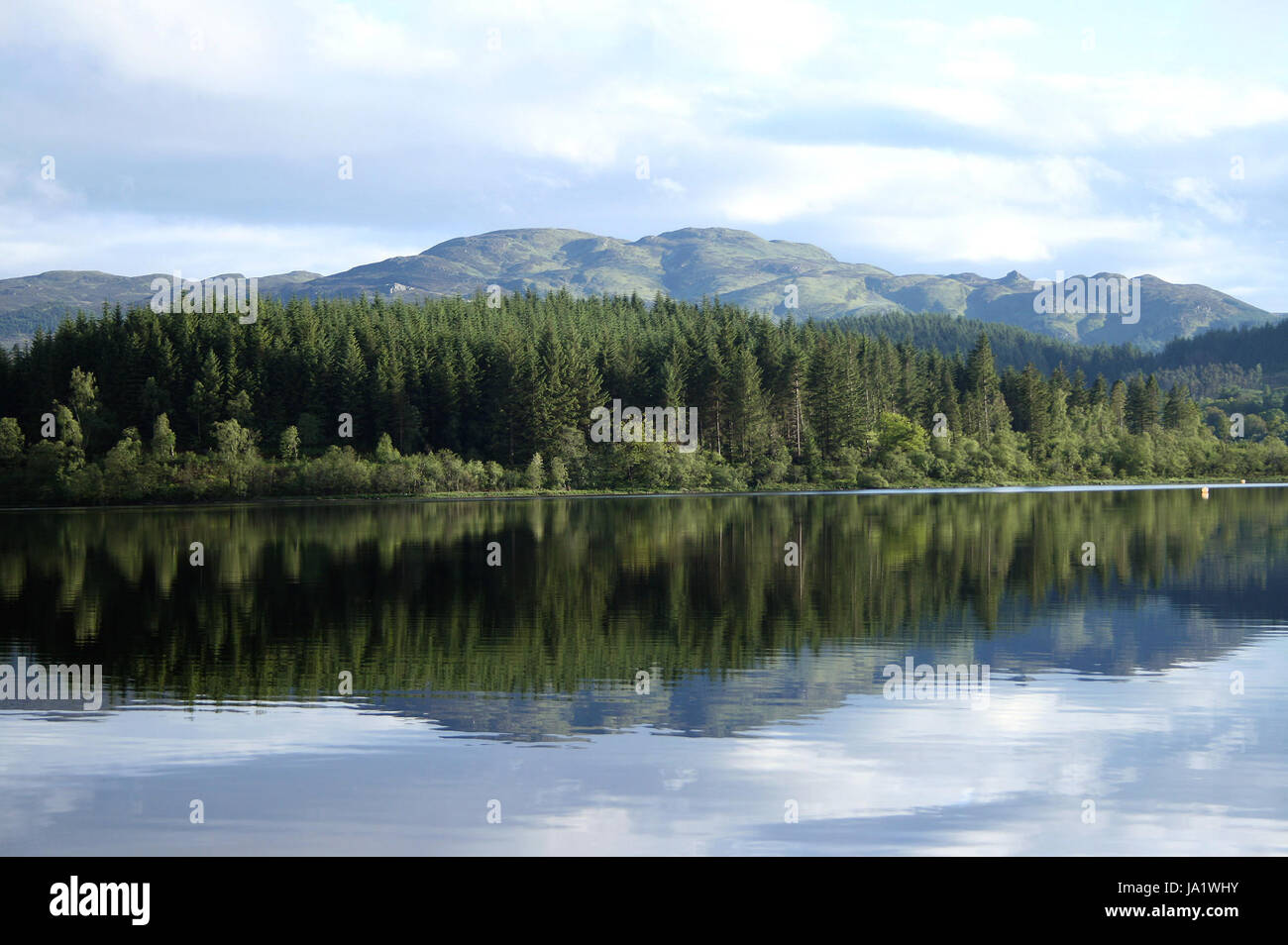 reflection of the landscape in loch ard in scotland,united kingdom ...