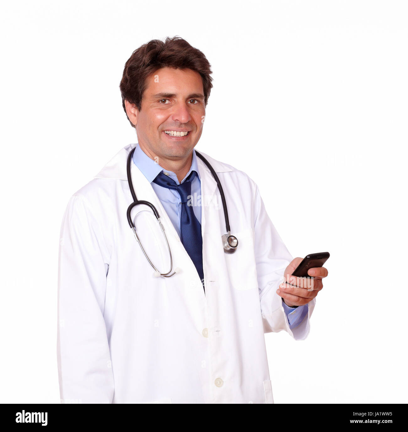Portrait of a smiling latin medical doctor sending message by cellphone ...