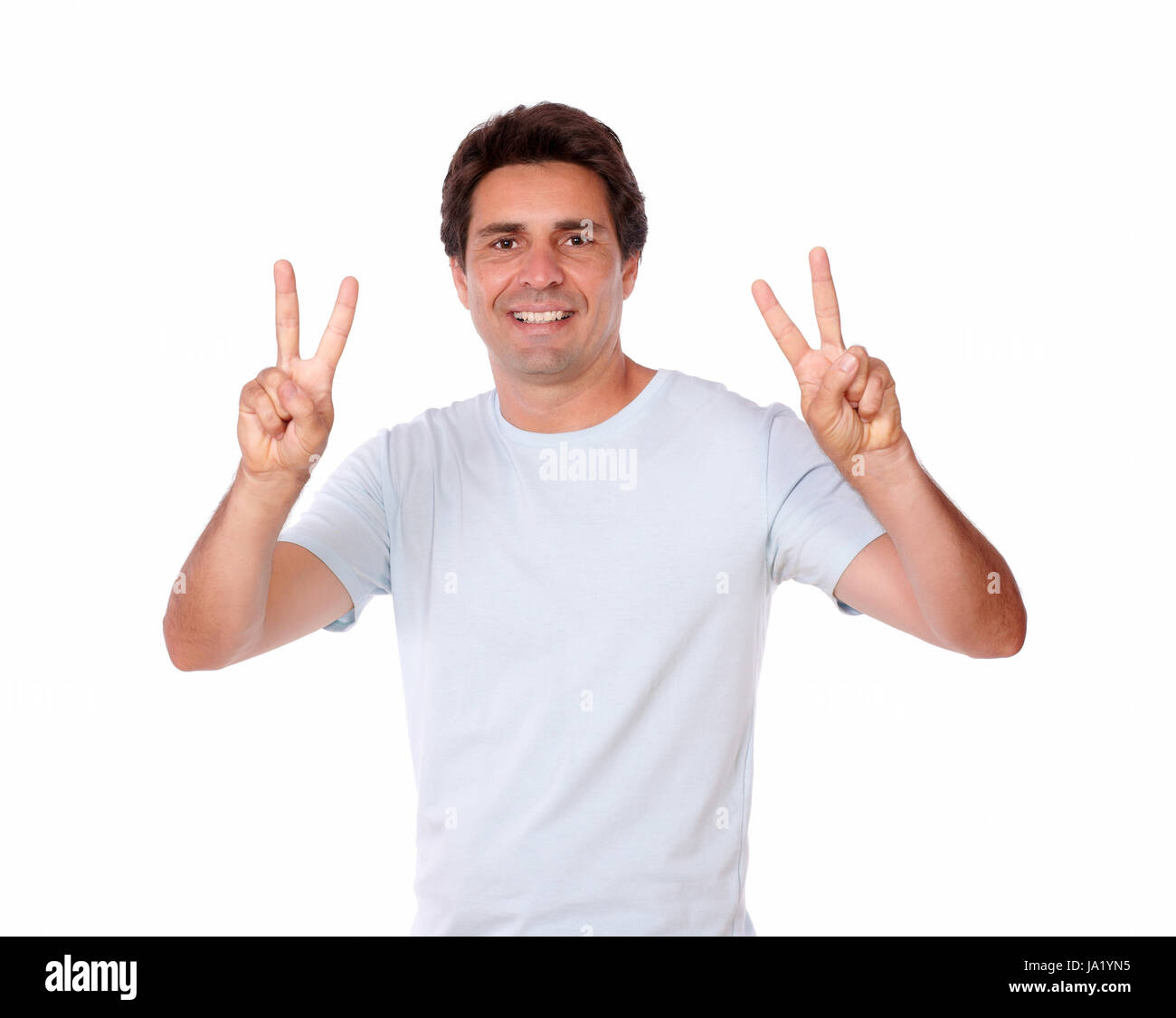 Portrait of a handsome guy showing victory sign with fingers on white ...