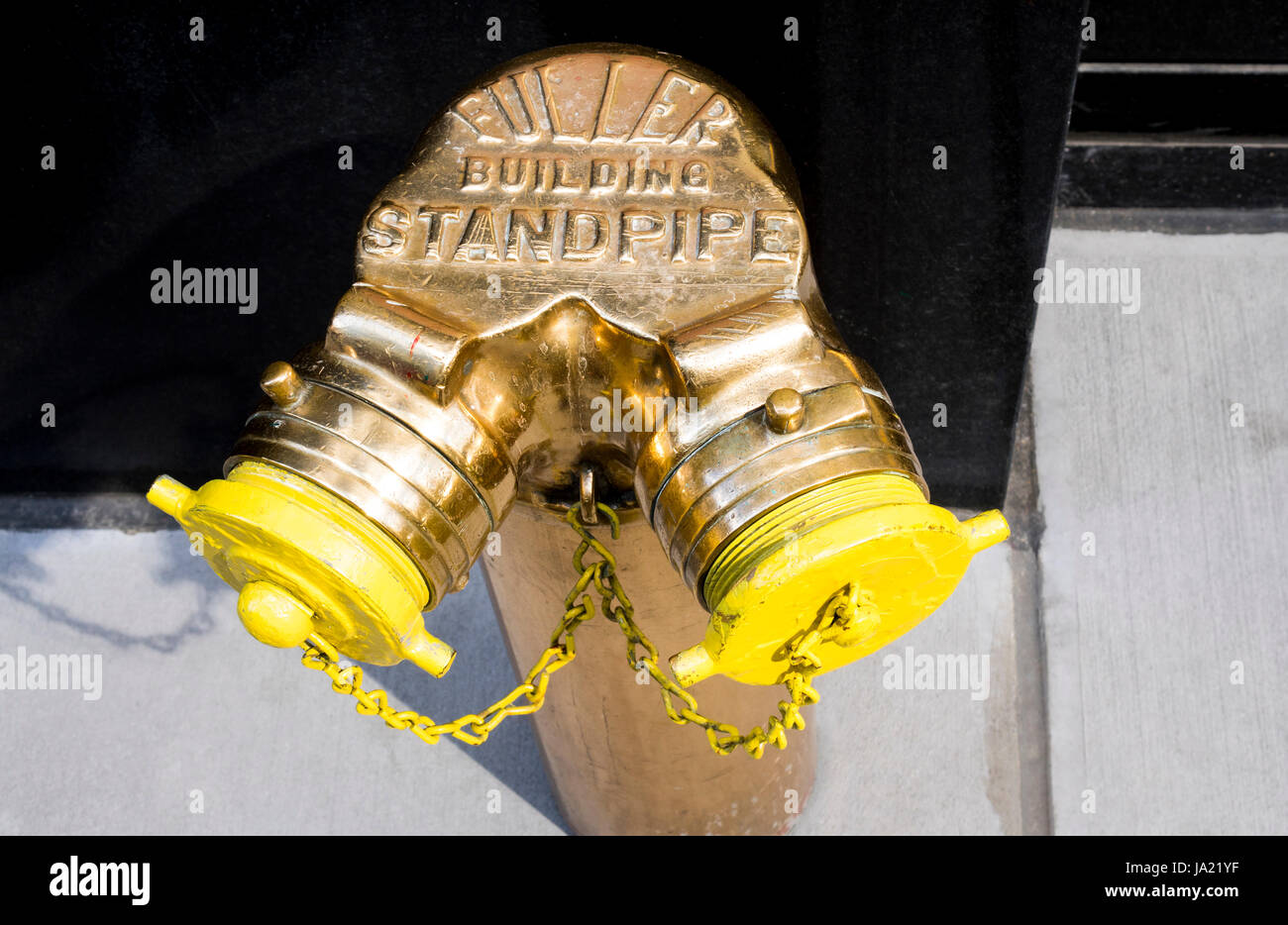 Gold and yellow standpipe in front of a building on 57th Street Stock ...