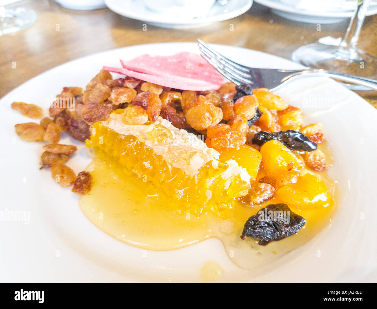 Raisins and honey with close up view Stock Photo - Alamy