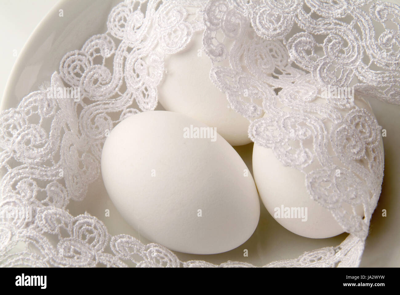 Snow white eggs and lace Stock Photo - Alamy