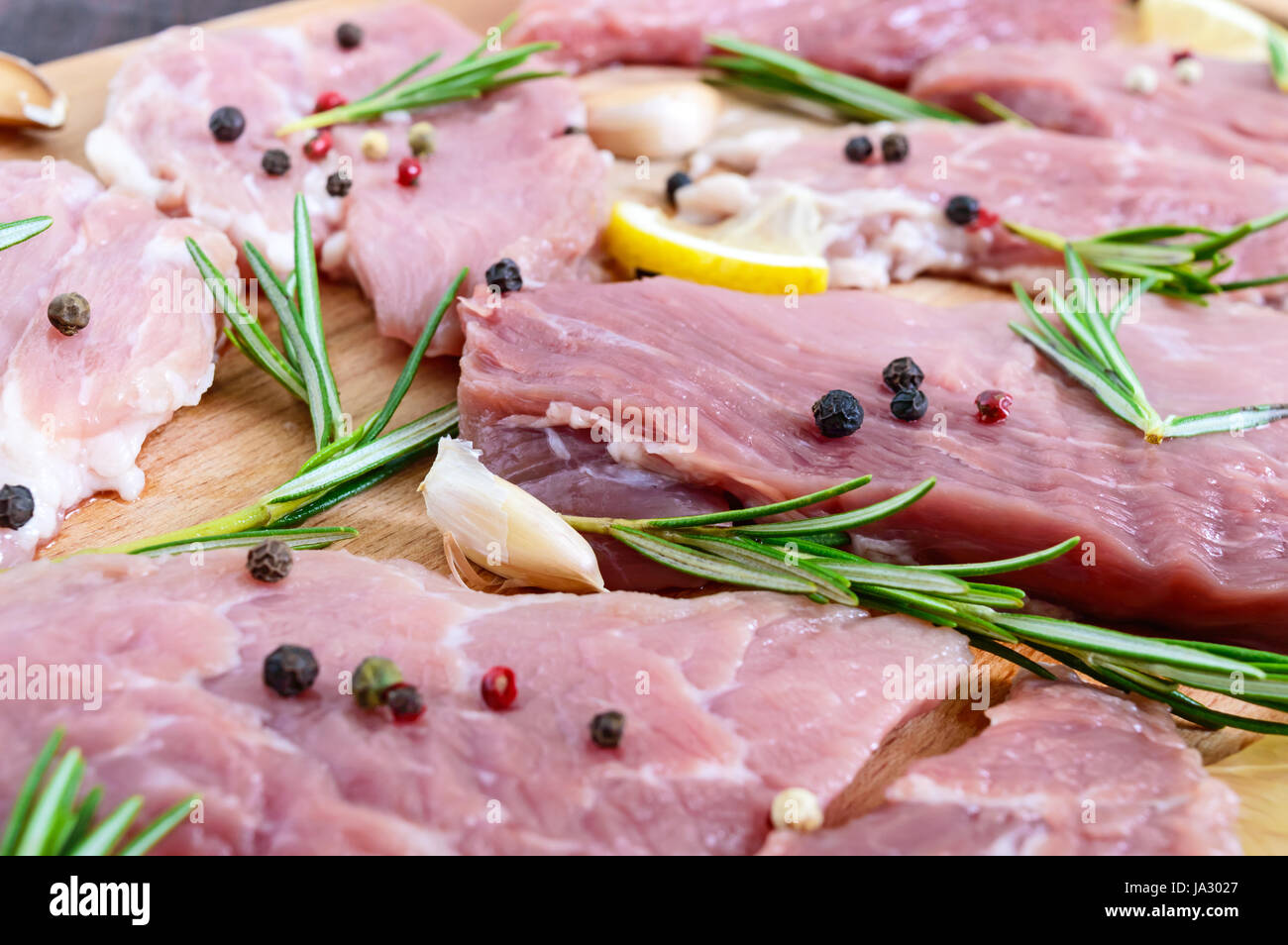 Raw flat meat for steak (chop) with spices on a cutting board. Close up ...