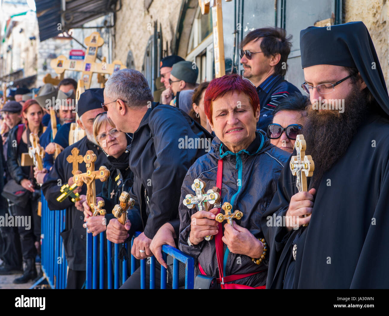 Christian pilgrims carry across along the Via Dolorosa in Jerusalem ...