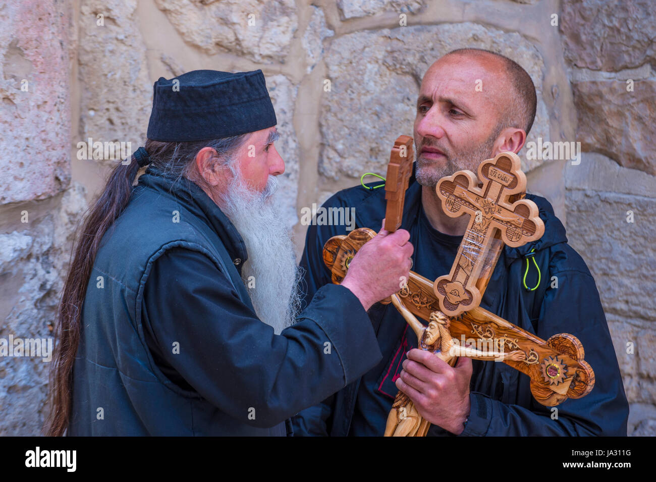 Christian pilgrims carry across along the Via Dolorosa in Jerusalem ...