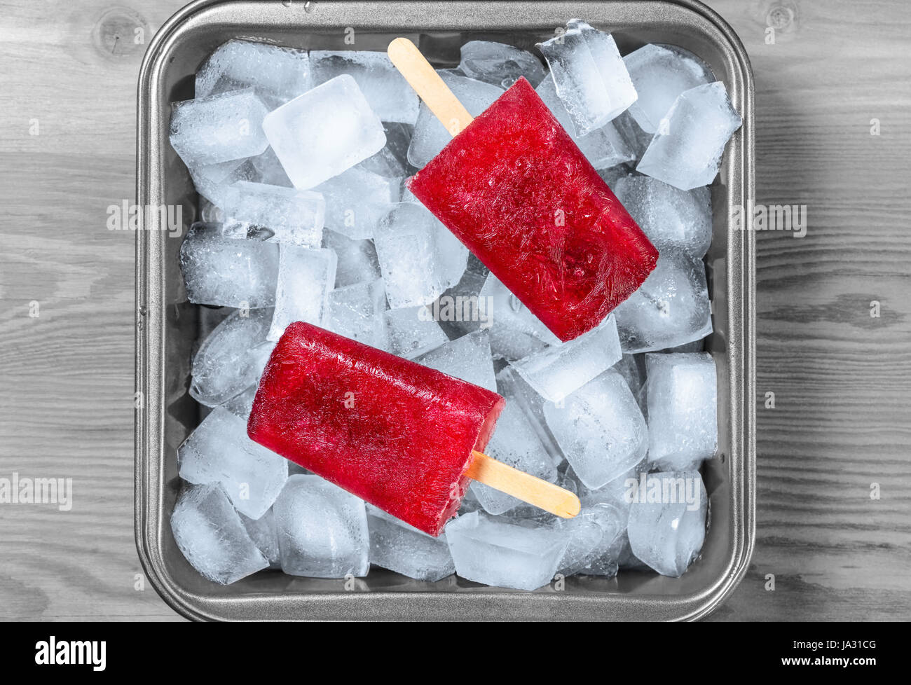 Frozen juice on stick closeup with ice cubes Stock Photo - Alamy