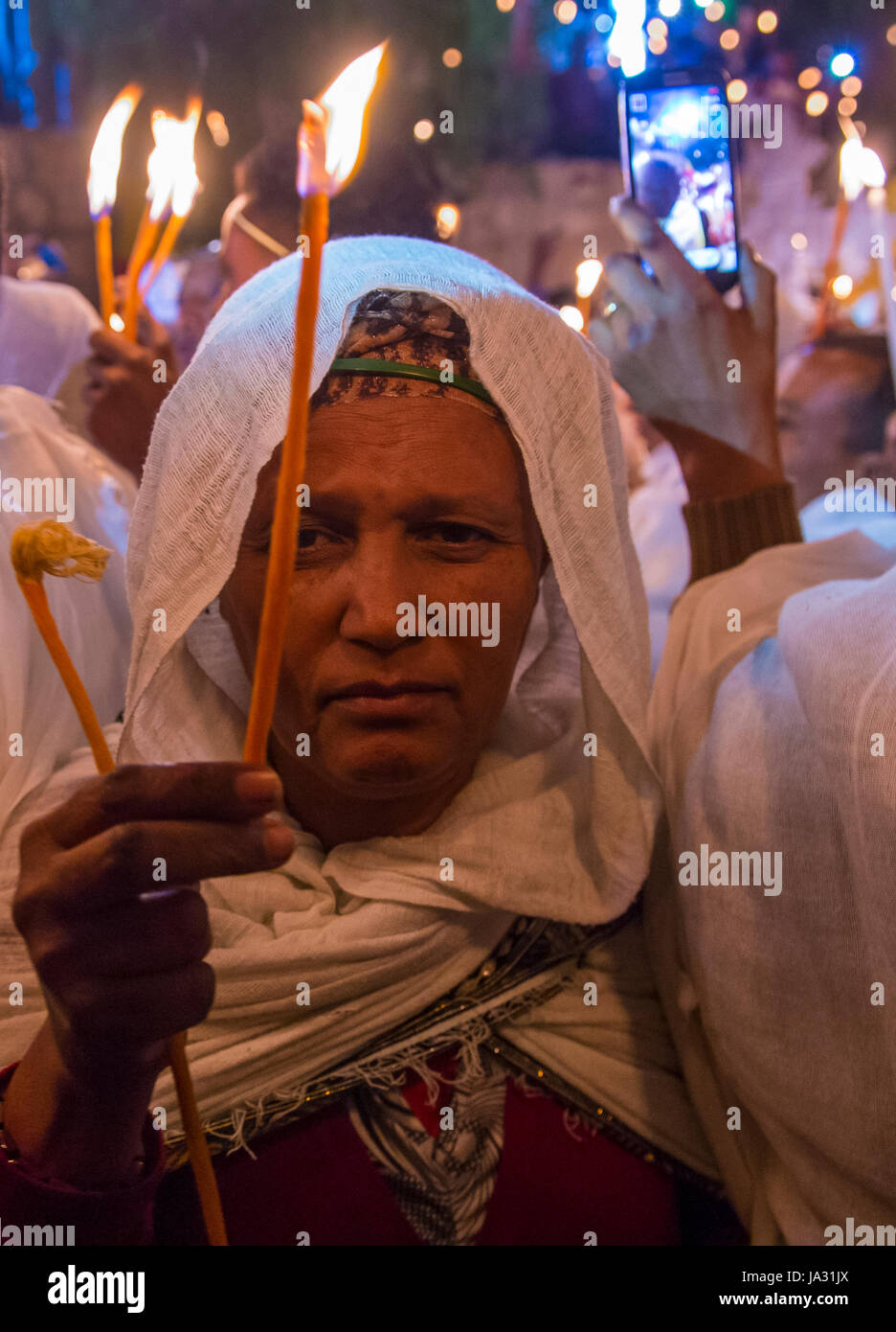 Ethiopian Orthodox pilgrim participates in the Holy fire ceremony at ...